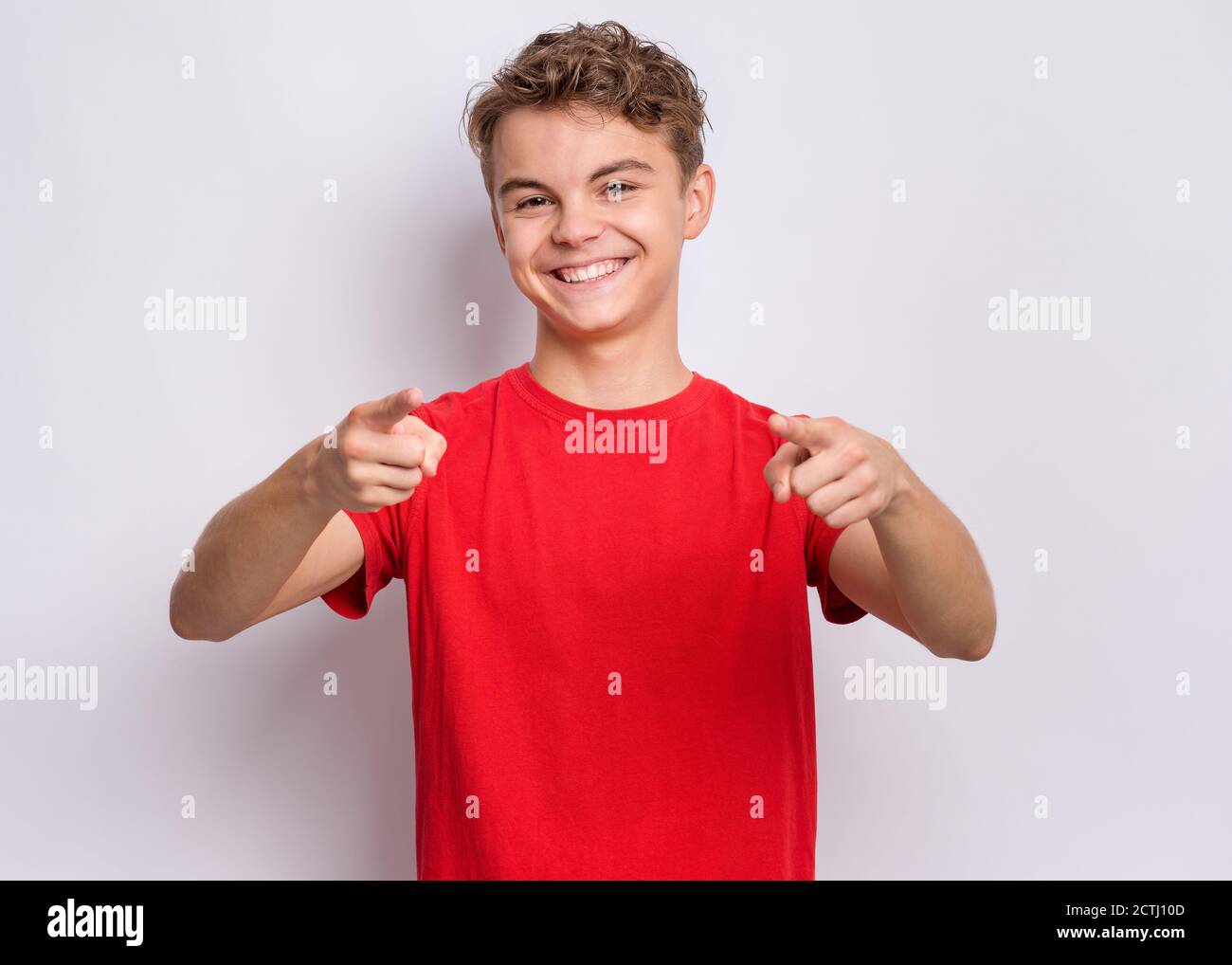 Portrait of happy teen boy pointing fingers at camera. Cute smiling ...