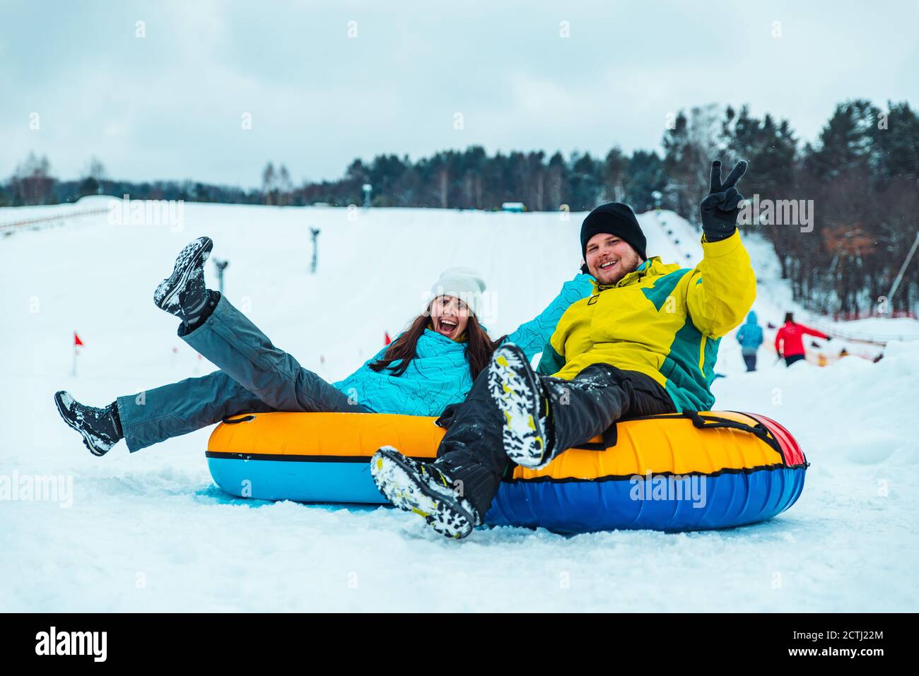 Couple snow tubing hi-res stock photography and images - Alamy