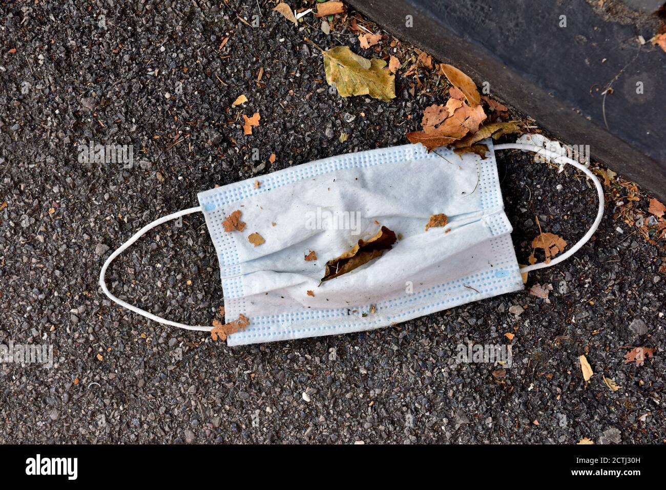 Discarded disposable face mask ending as waste on pavement in city ...