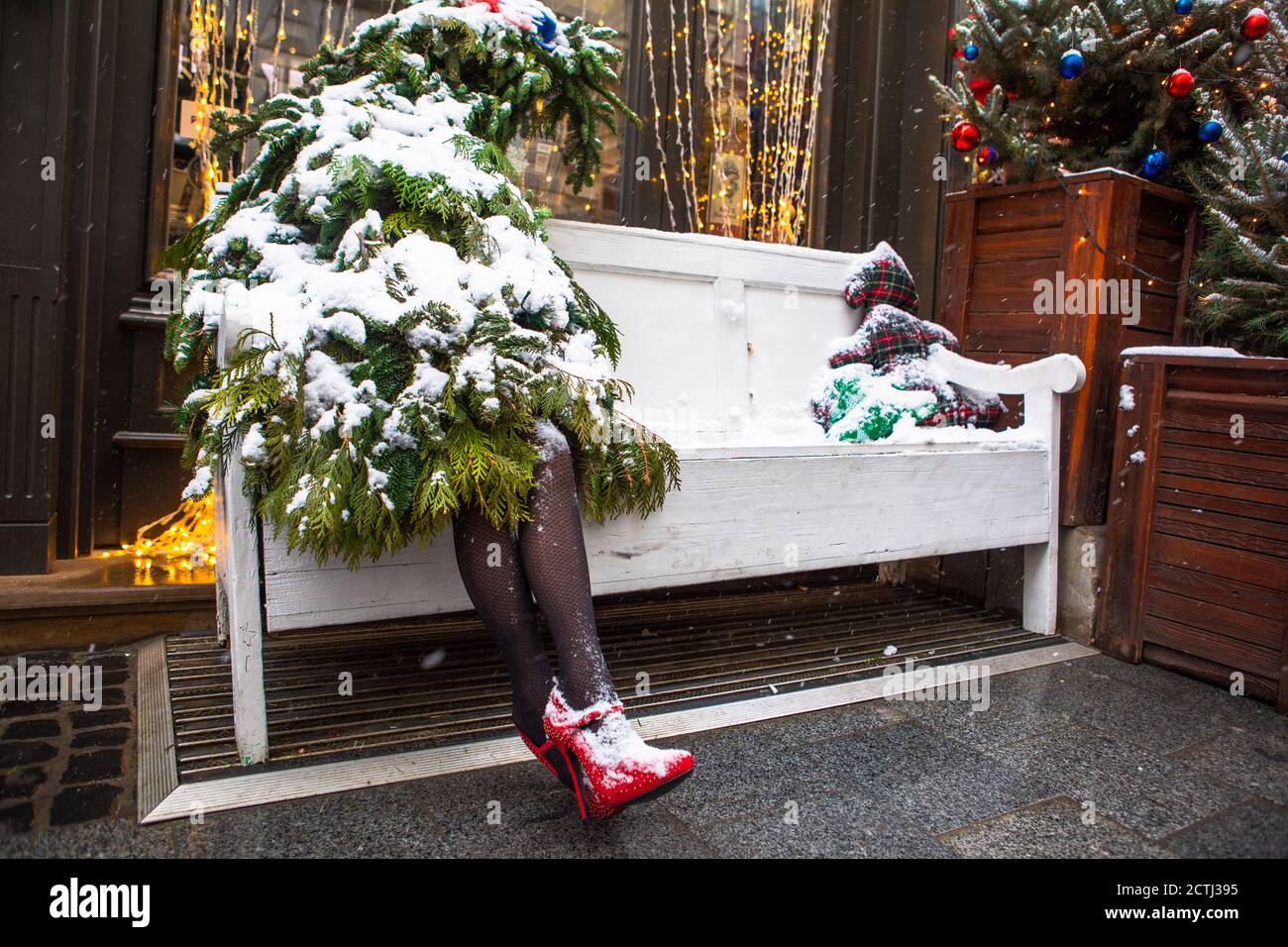 christmas tree with woman legs sitting on wooden bench Stock Photo - Alamy