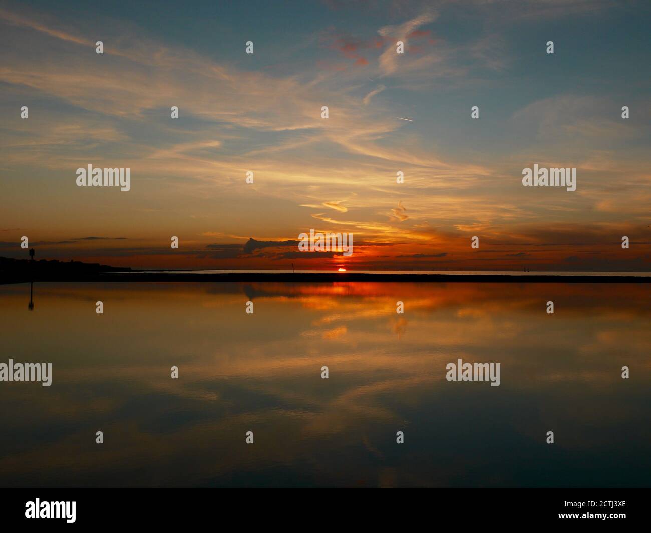 Sunset reflections over tidal pool Stock Photo - Alamy