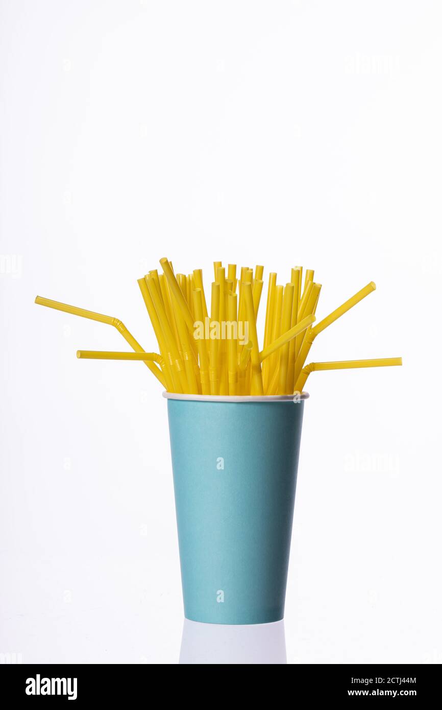 yellow plastic straws in blue disposable biodegradable paper cup ...