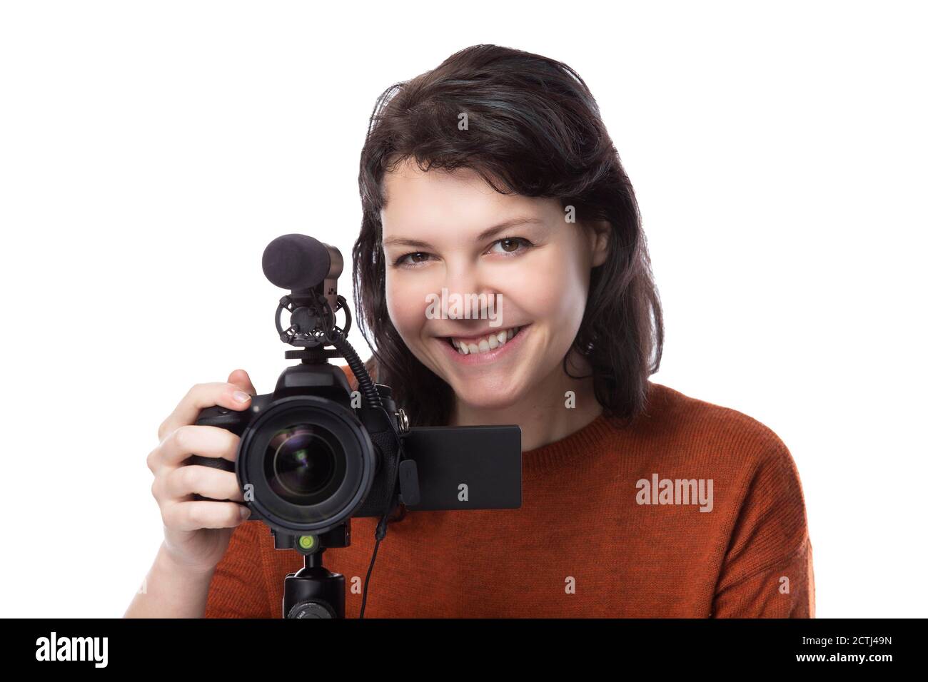Young female with a camera and mic as a filmmaker or online content ...