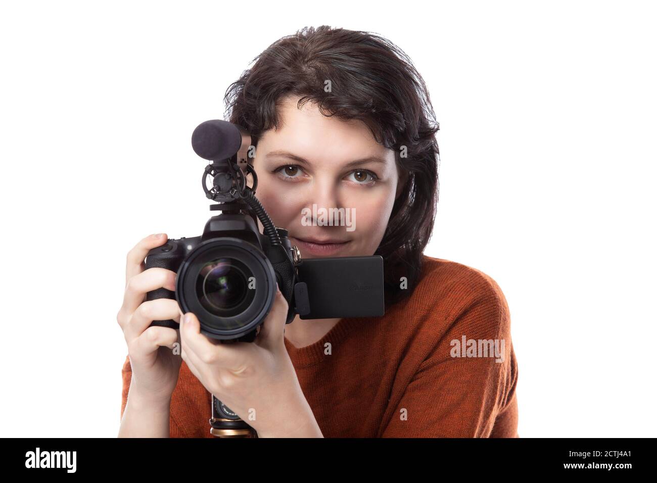 Young female with a camera and mic as a filmmaker or online content ...