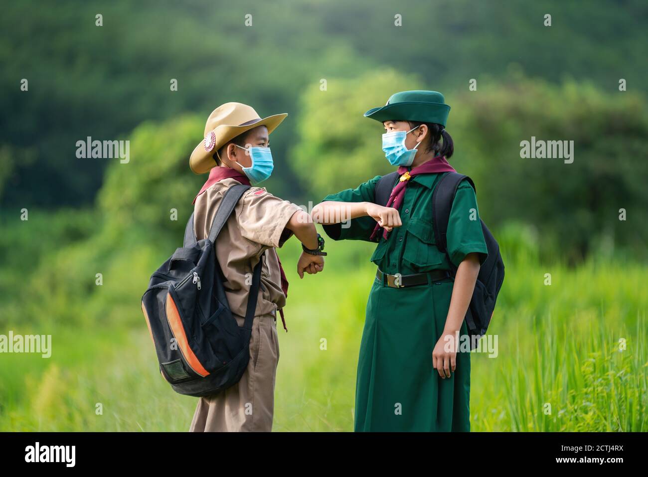Asian Scout wearing a mask and Show a new normal greeting Stock Photo ...
