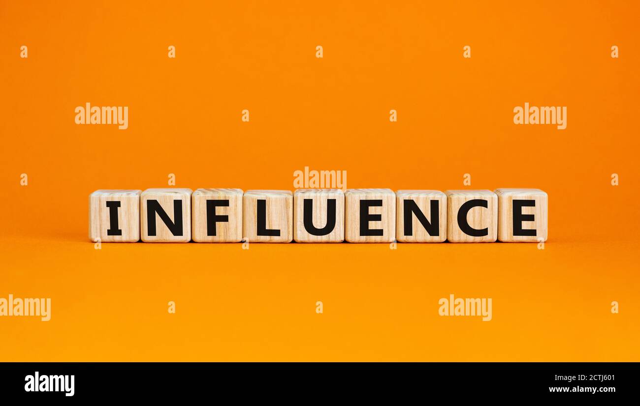 Wooden cubes with word 'influence'. Beautiful orange background ...