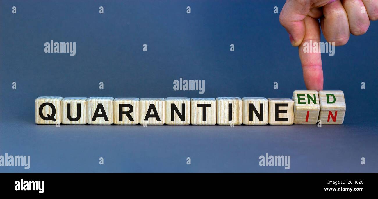 Male hand turns cubes and changes the expression 'quarantine in' to ...