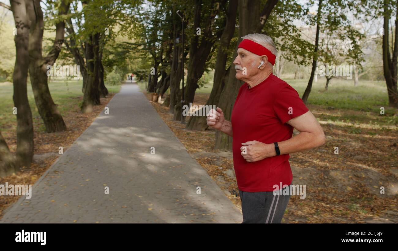 Side view of elderly sport runner man training. Workout cardio outside ...