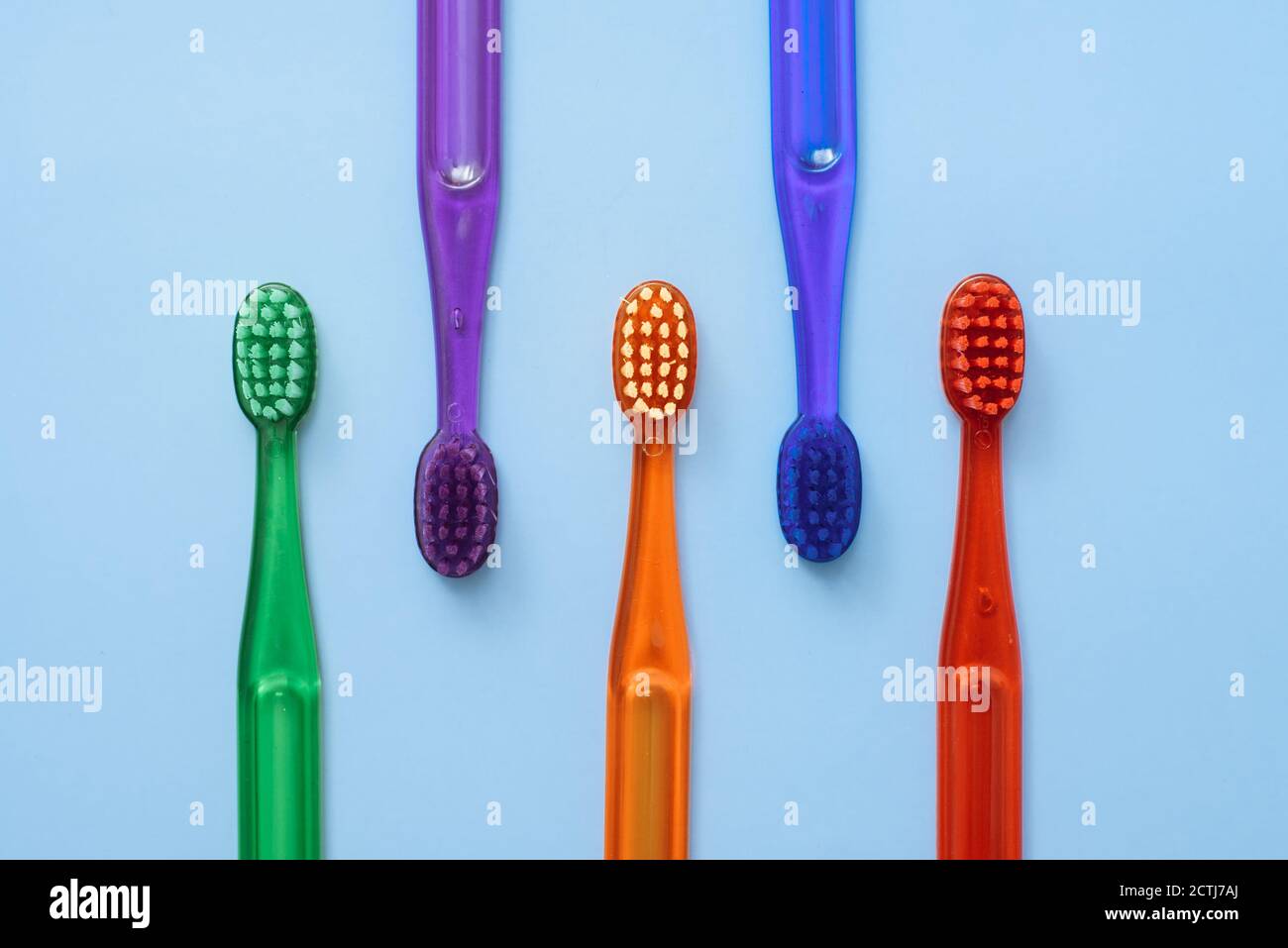 Top view of toothbrushes in colorful on pastel color blue background ...