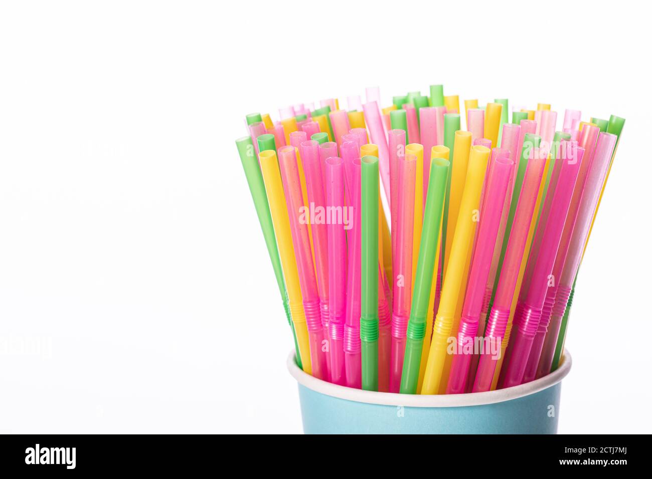multi colored plastic straws in disposable paper cup isolated on white ...