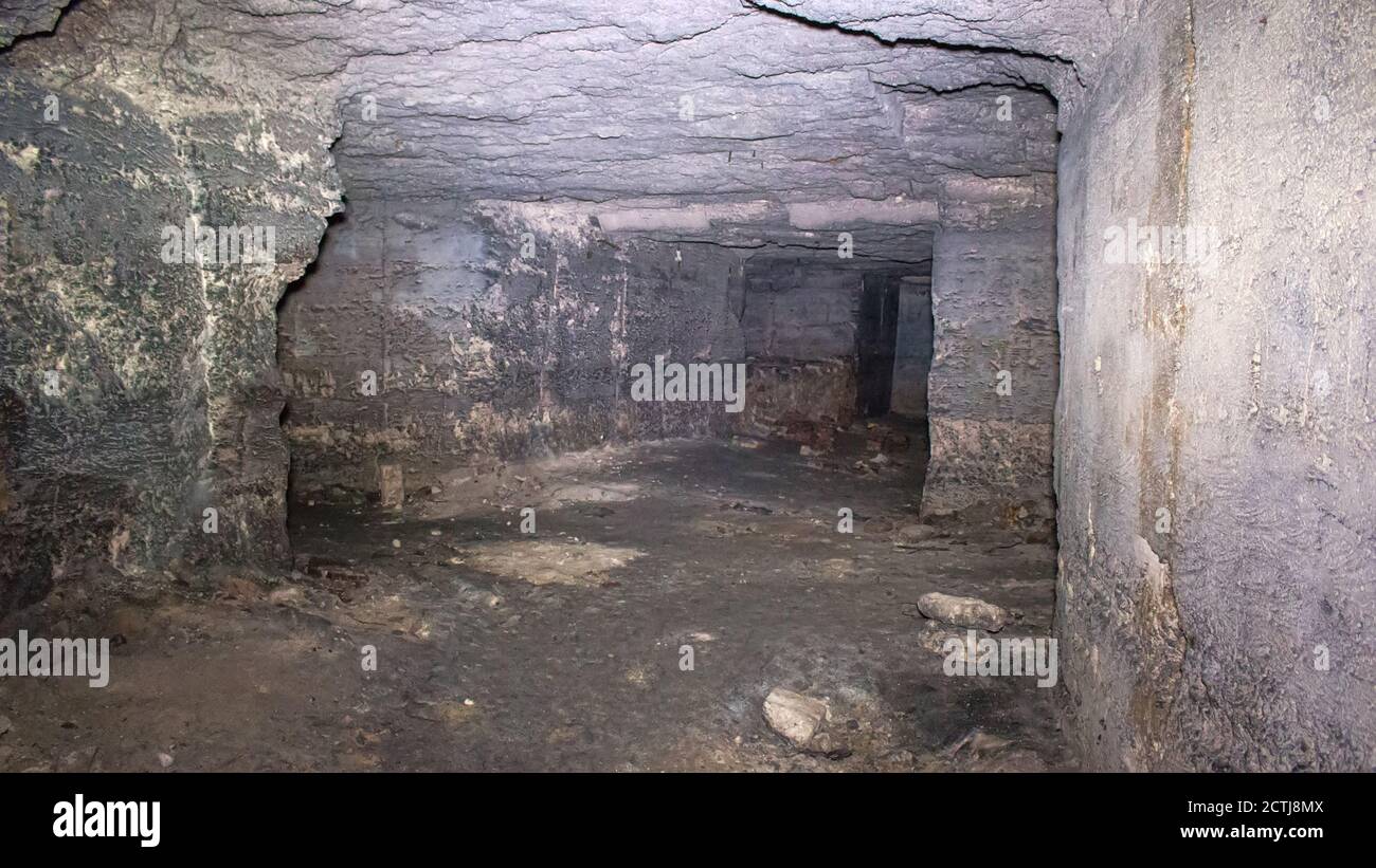 Old underground passage, dungeon, catacombs lined with stones ...