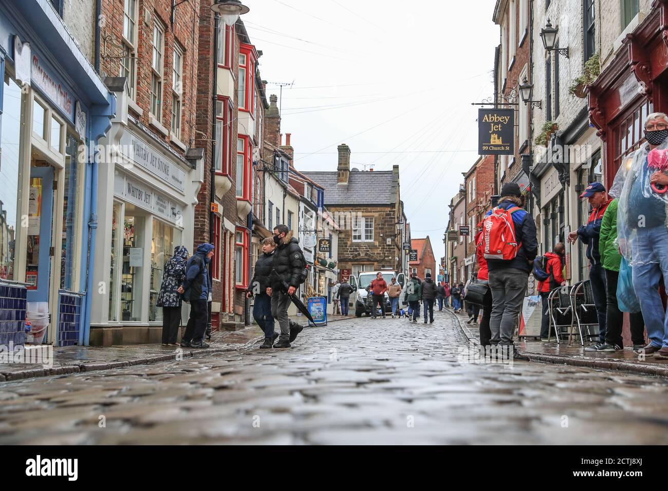 The back streets of Whitby remain busy as the rain continues to pour ...