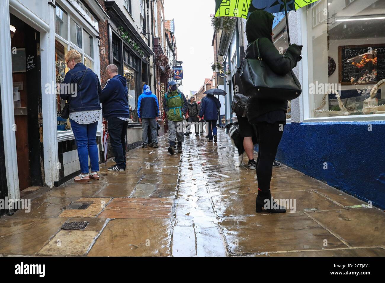 The back streets of Whitby remain busy as the rain continues to pour ...