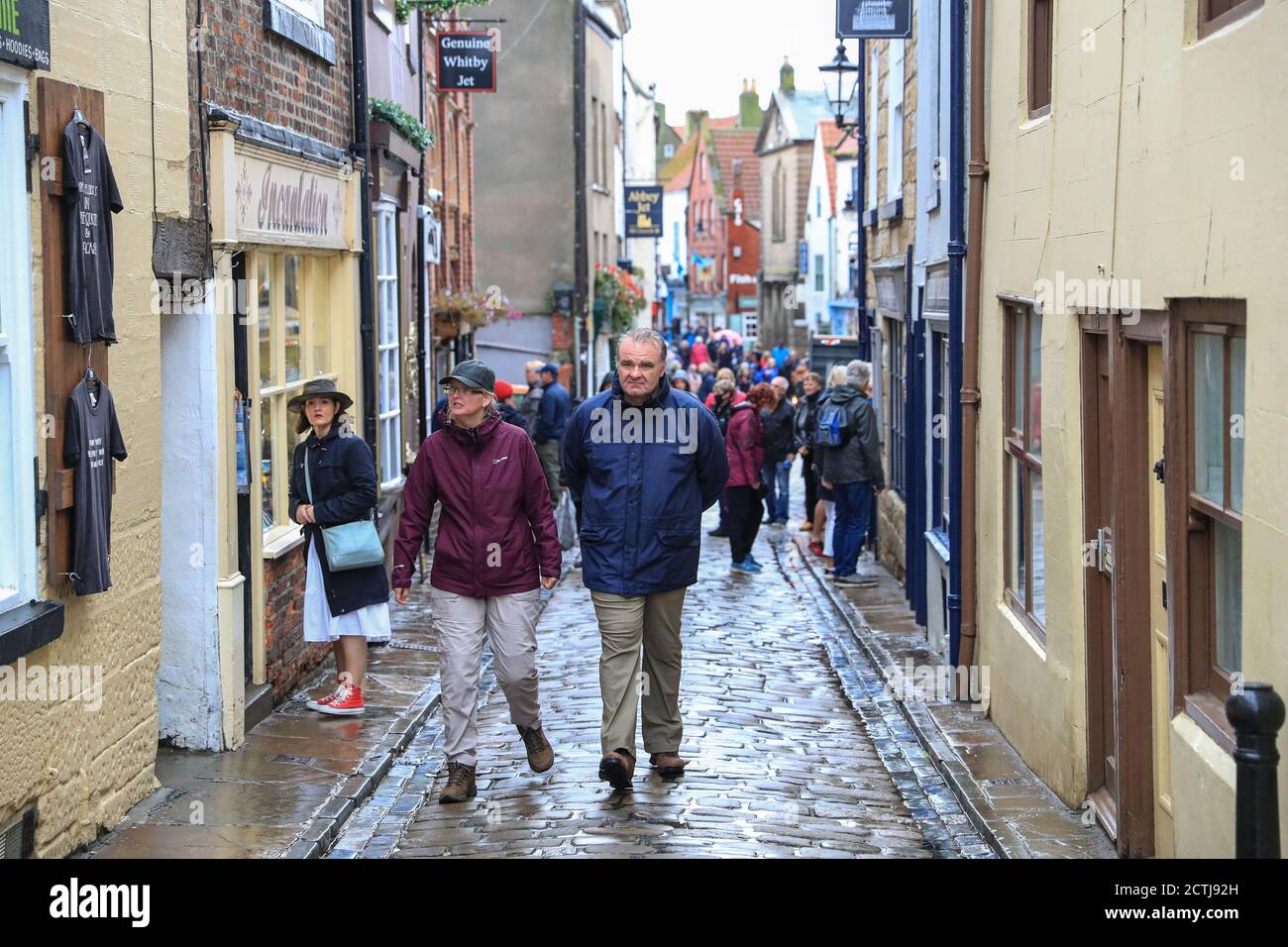 The back streets of Whitby remain busy as the rain continues to pour ...
