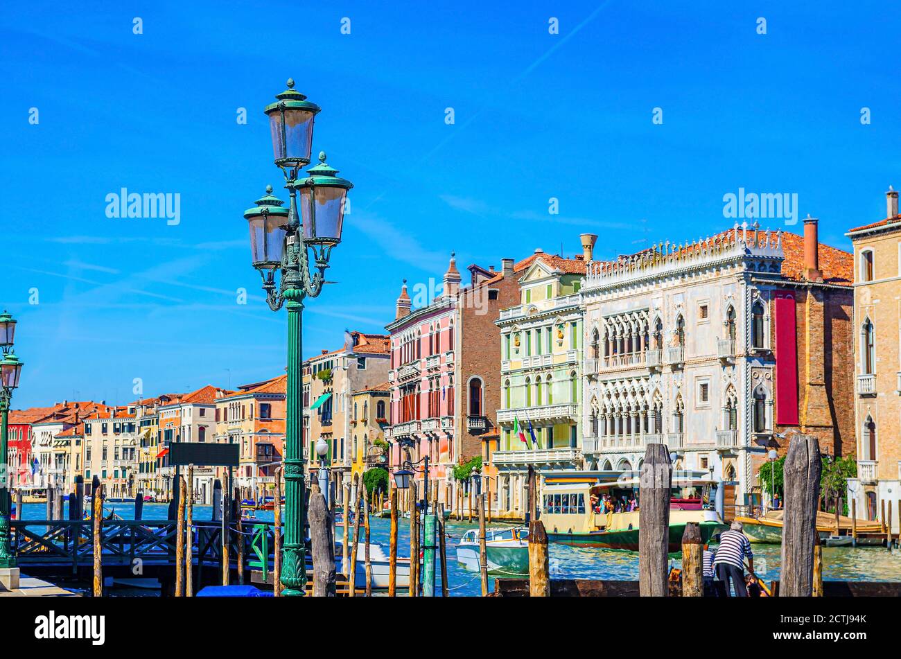 Pier dock with wooden poles of Grand Canal waterway in Venice ...