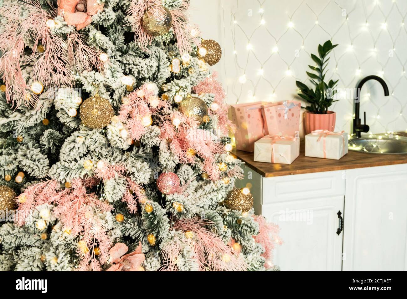 Christmas tree and gifts in the interior Stock Photo - Alamy