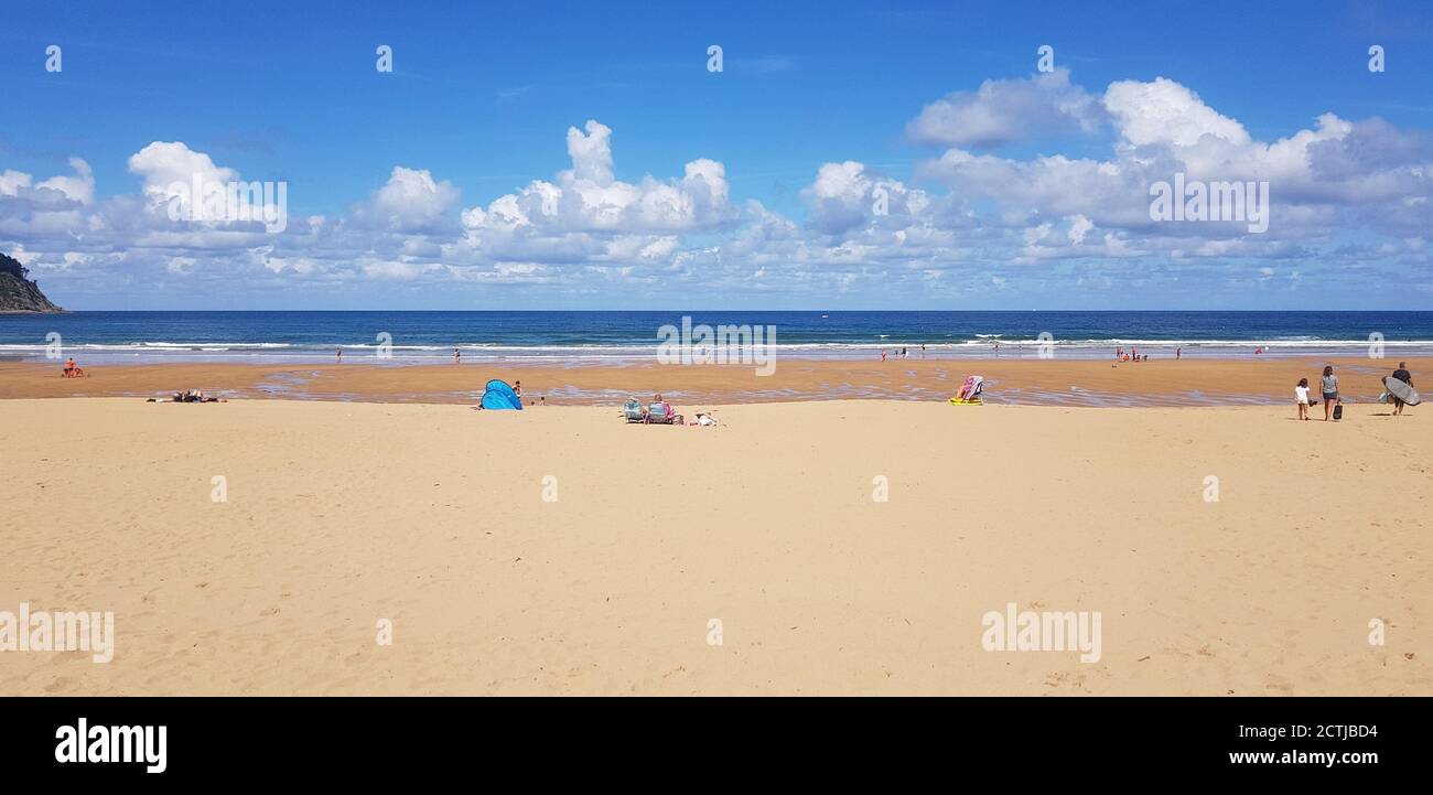 Sandy beach with people relaxing in the summer Stock Photo - Alamy