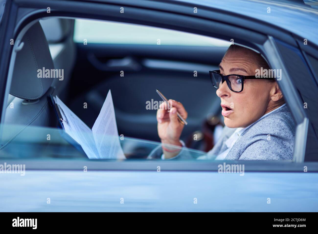 Car accident. Shocked and scared business woman looking looking out of ...