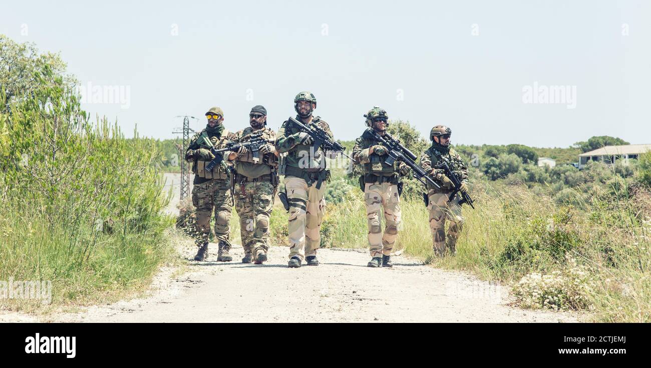 Army soldiers team in combat uniform, load carriers and helmets running ...