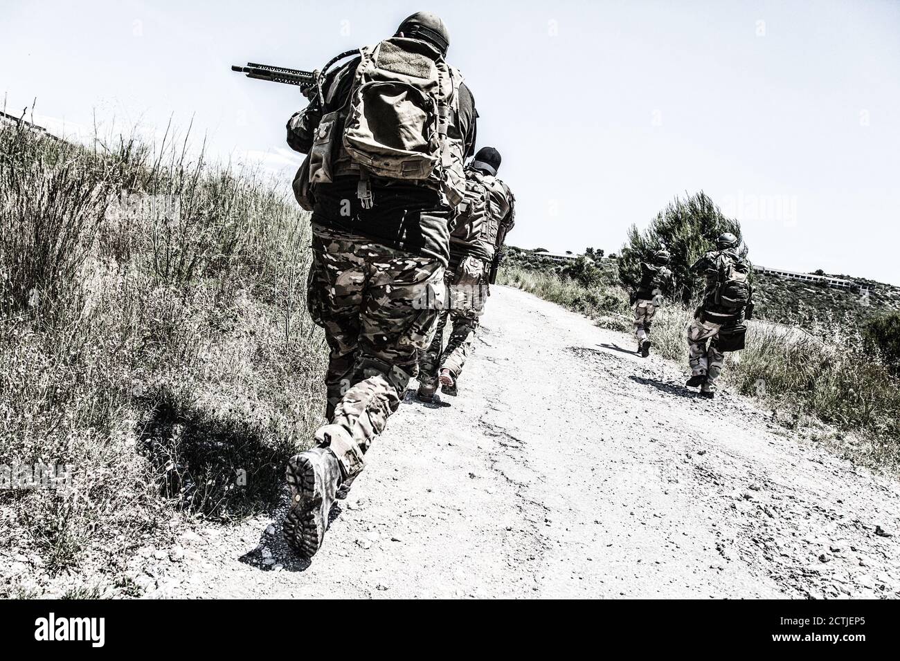 Army soldiers team in combat uniform, load carriers and helmets running ...