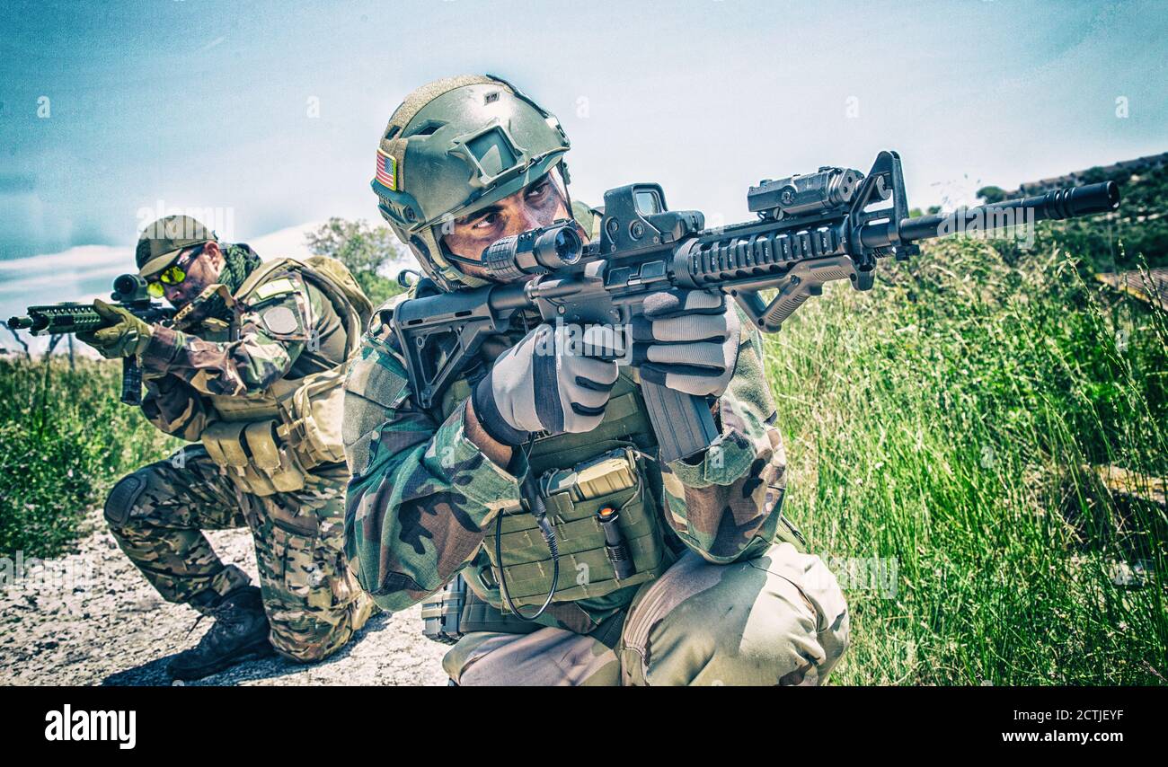 Army soldiers, SEALs team fighters in full ammunition, aiming assault ...