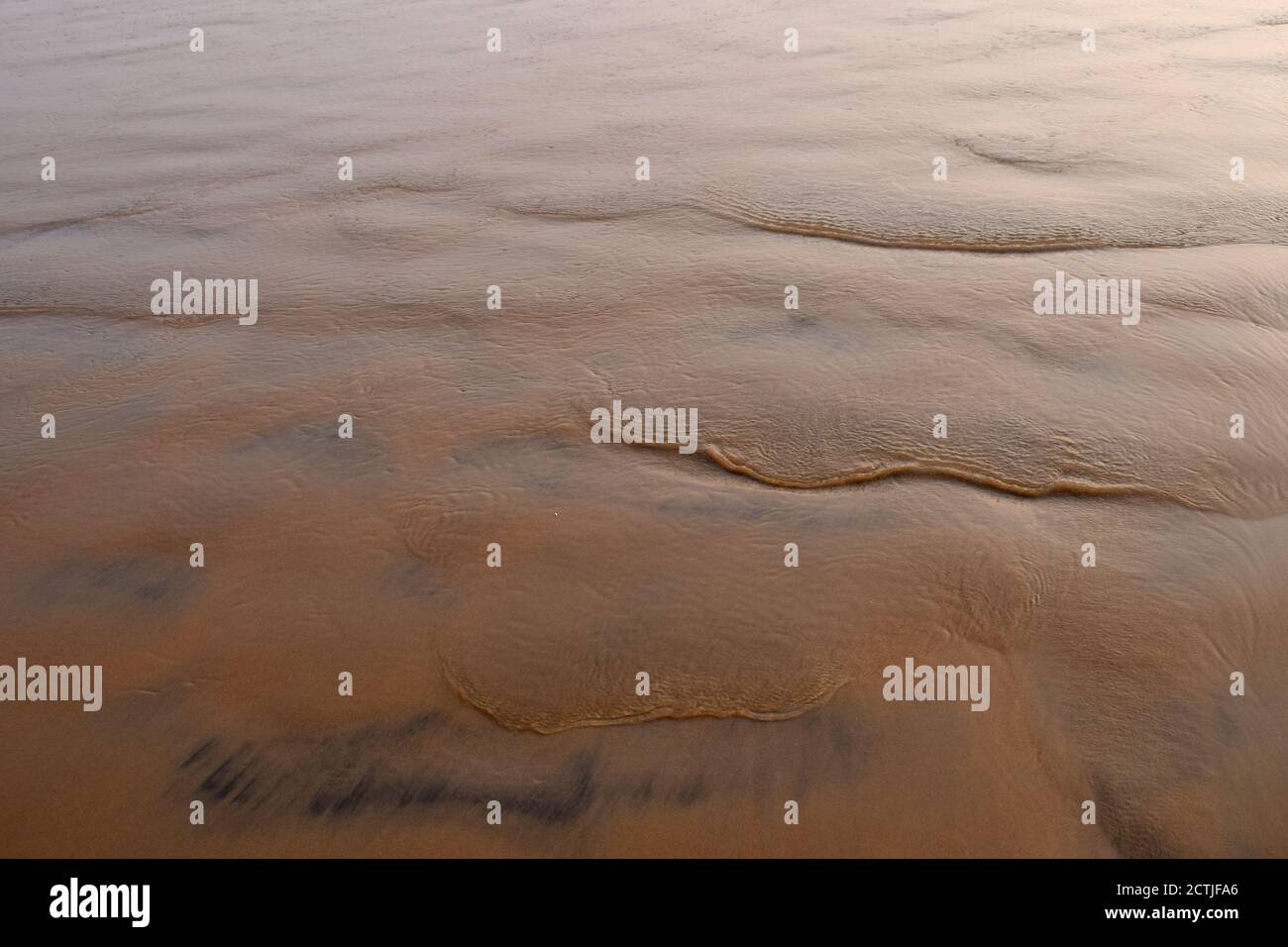 Waves pattern on sand beach. Close up to sand texture with wave marks ...