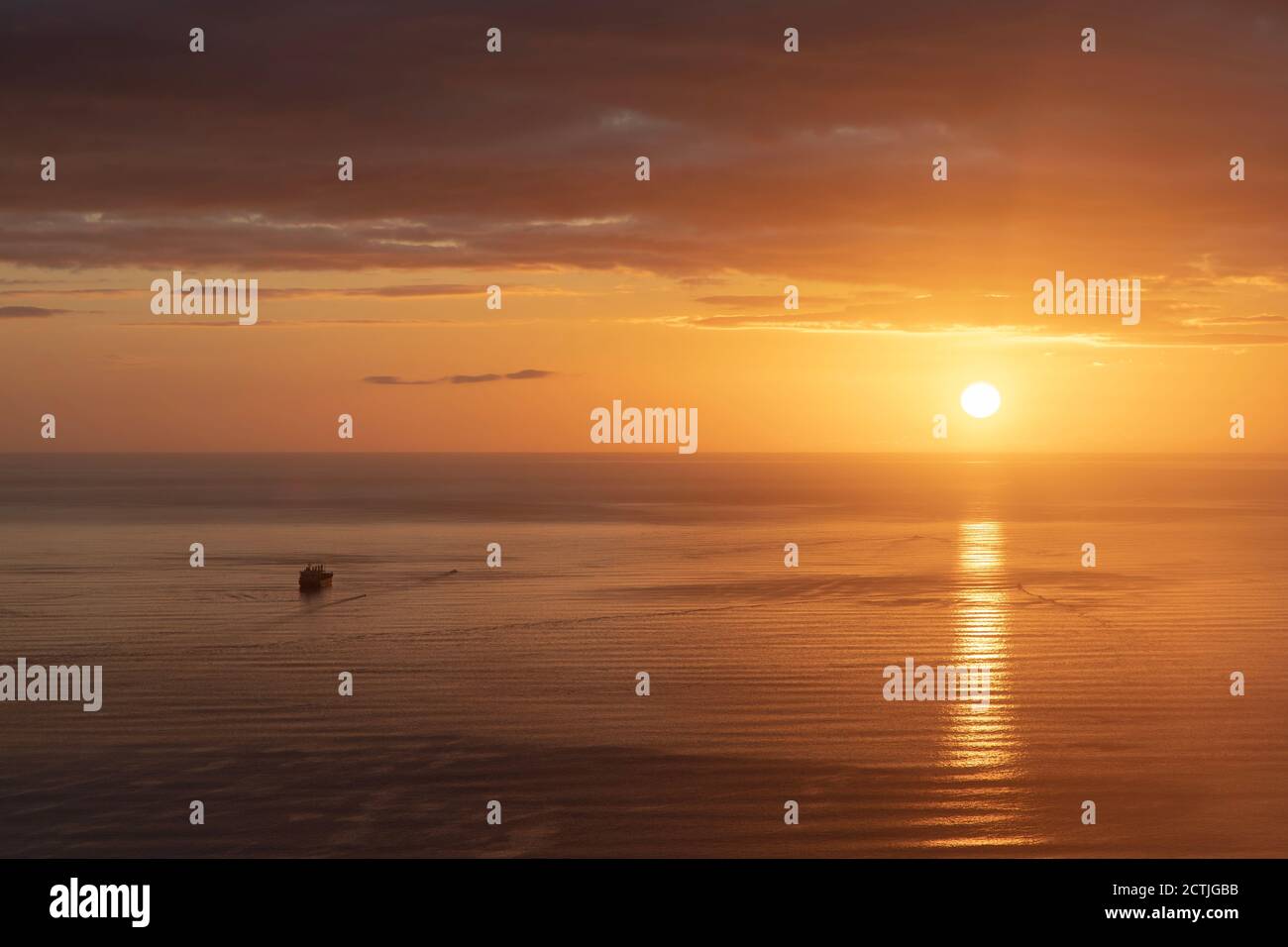 Cargo ship sailing sunset hi-res stock photography and images - Alamy