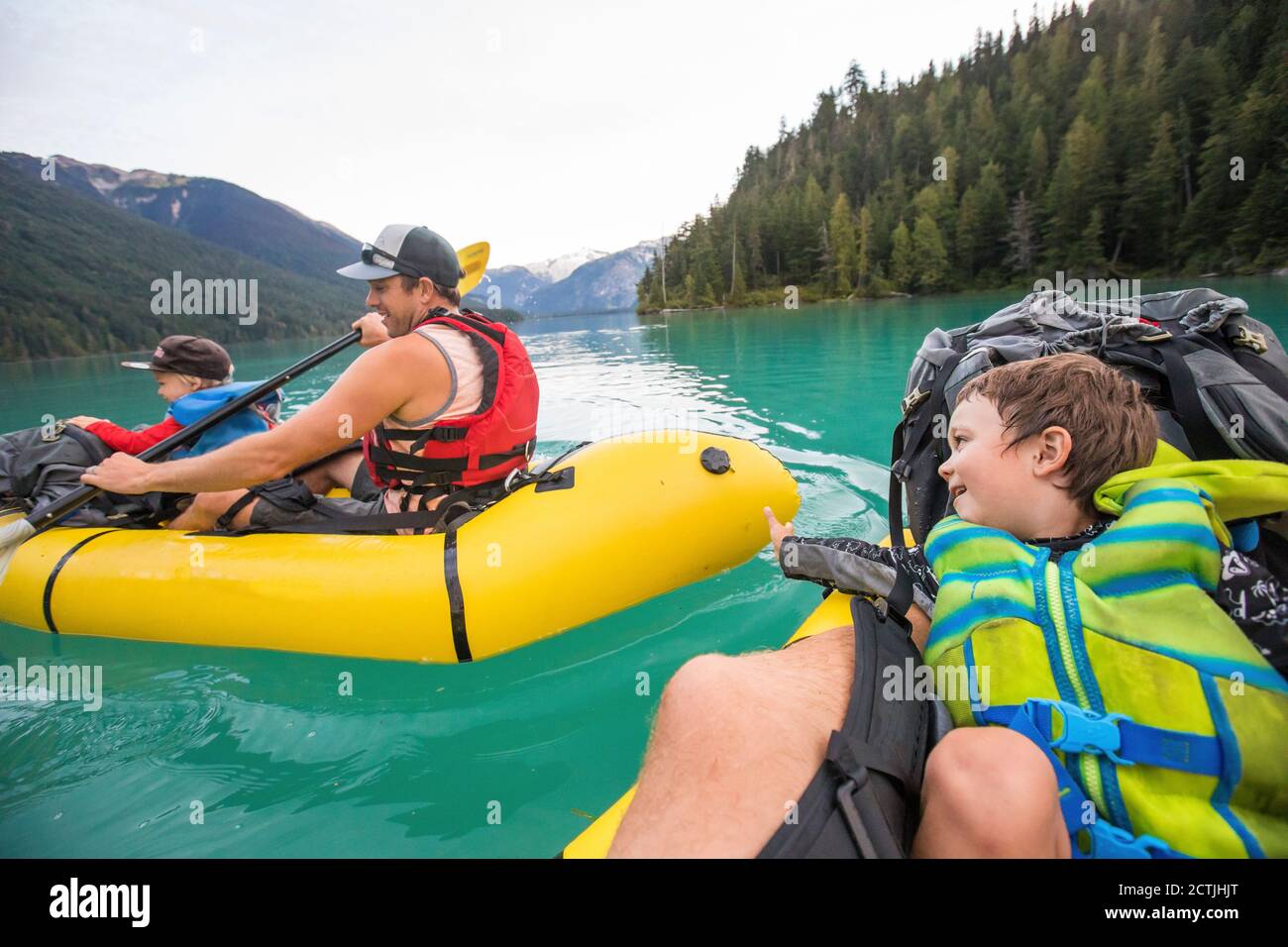 Young boy reaches out to touch his friends inflatable boat Stock Photo ...