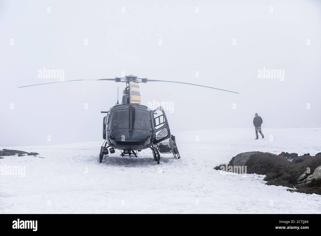 Helicopter pilot waits for improved visibility as weather changes Stock ...