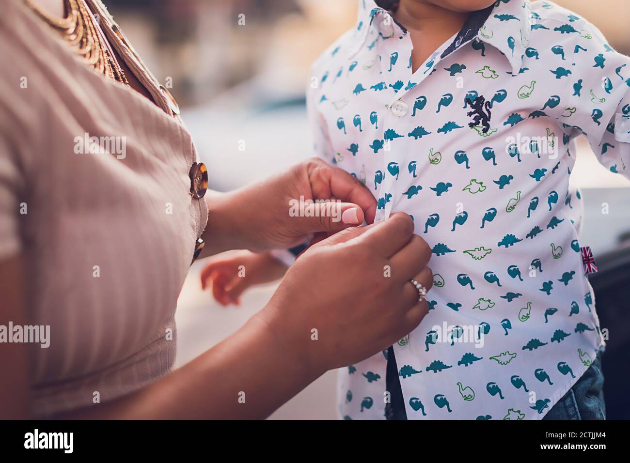 Mother buttoning shirt son hi-res stock photography and images - Alamy