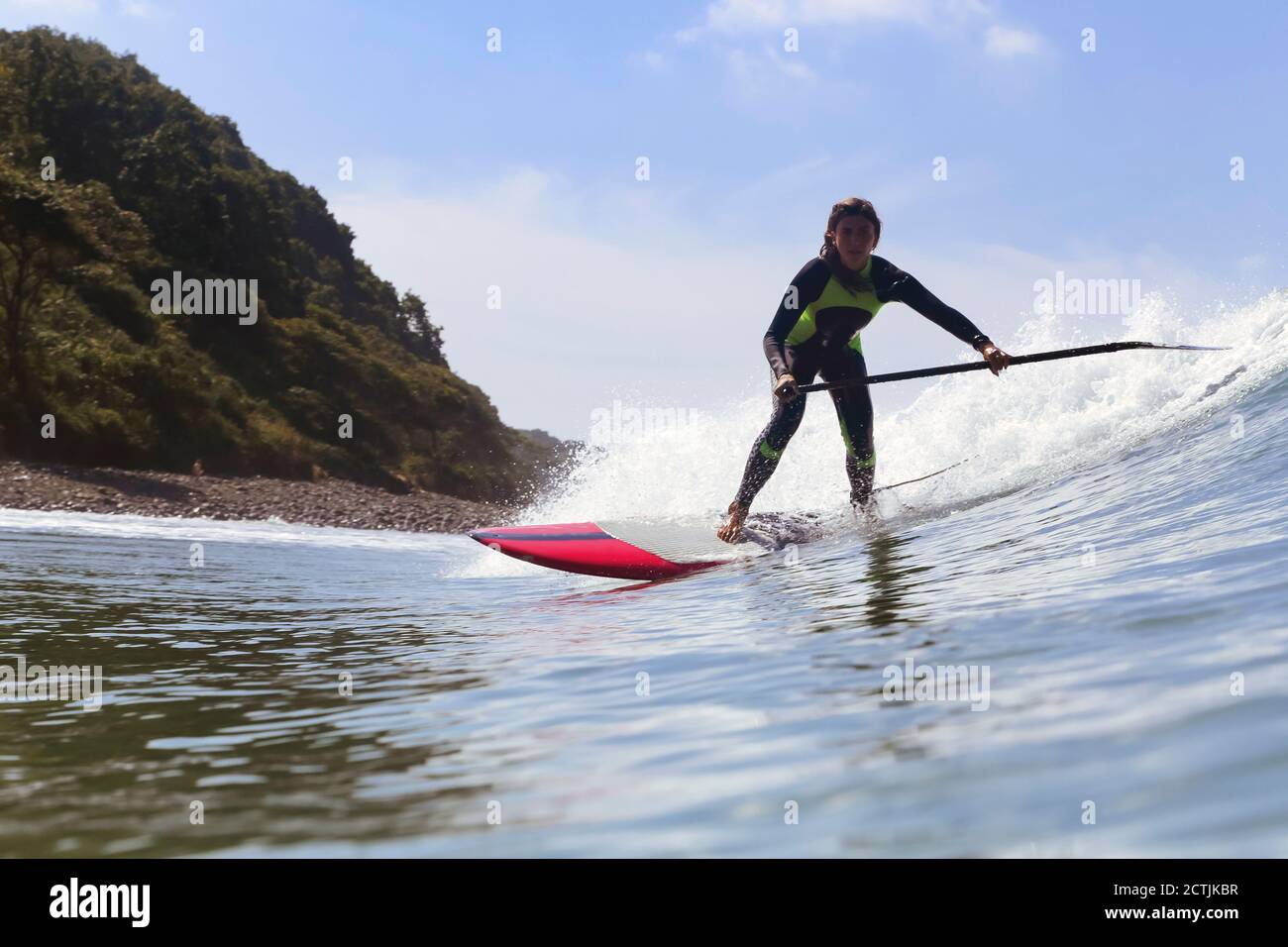 Female SUP surfer on a wave Stock Photo - Alamy