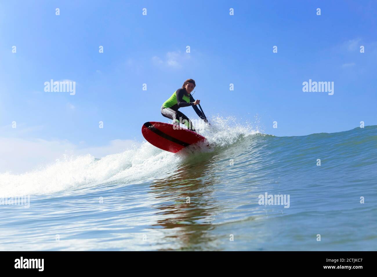Female SUP surfer on a wave Stock Photo - Alamy