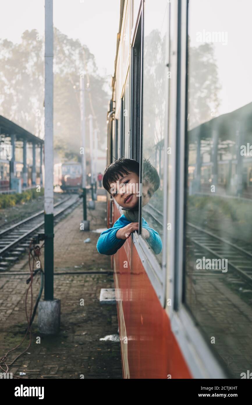 Young boy smiling through Toy Train window at Kalka Station, Haryana ...