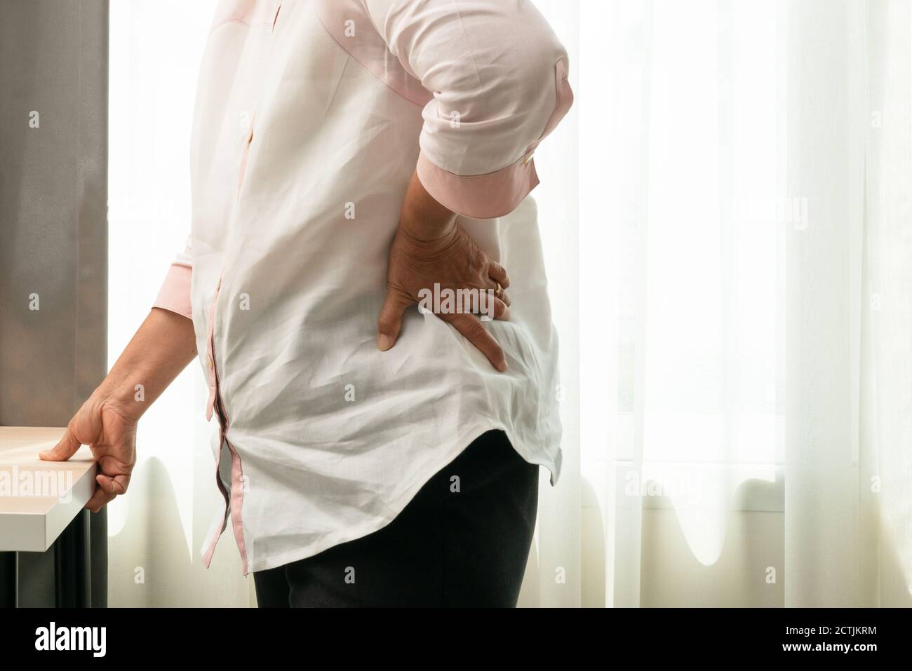 Old woman back pain at home, health problem concept Stock Photo - Alamy