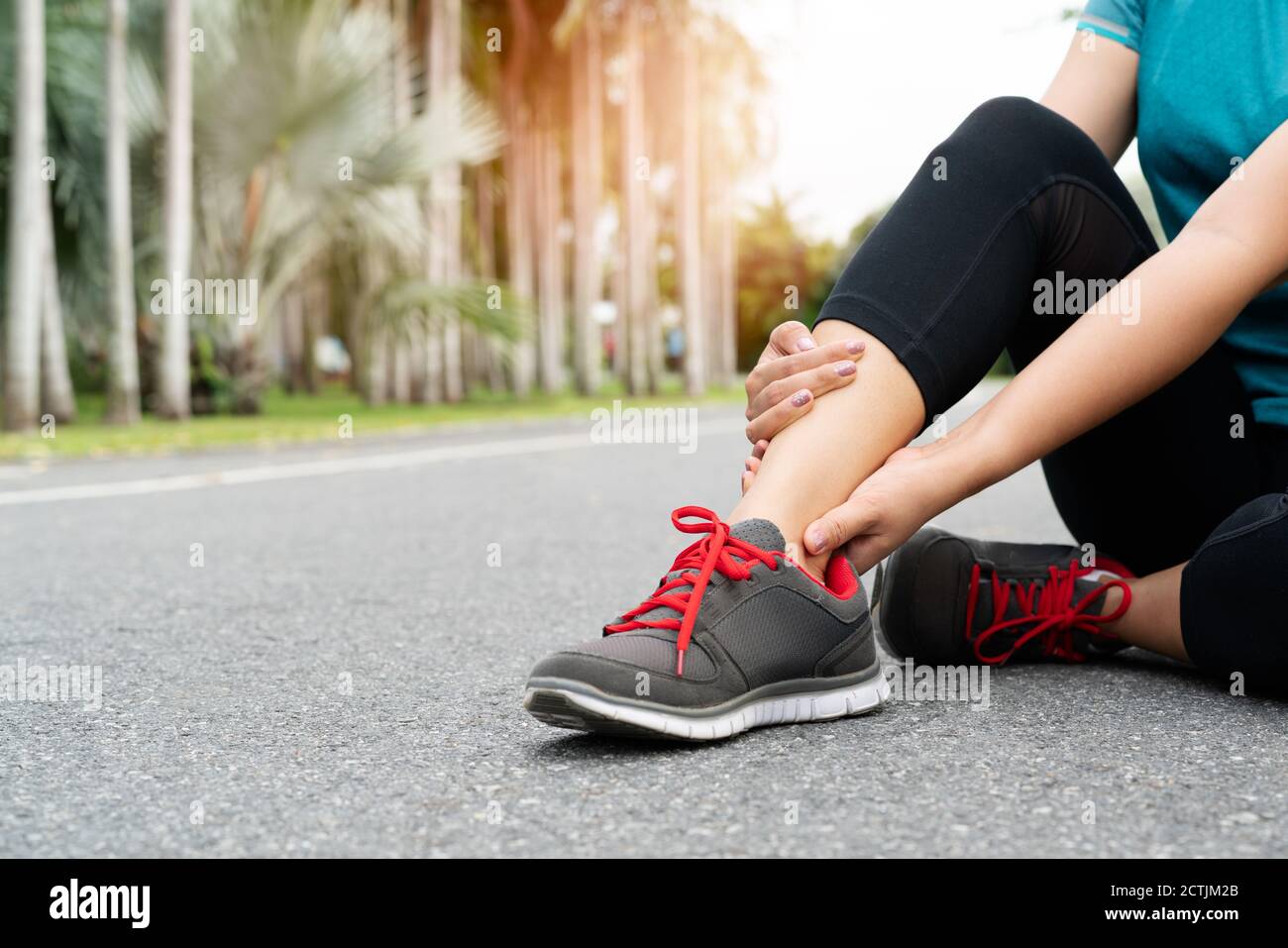 fitness woman runner feel pain on ankle leg. Outdoor exercise ...