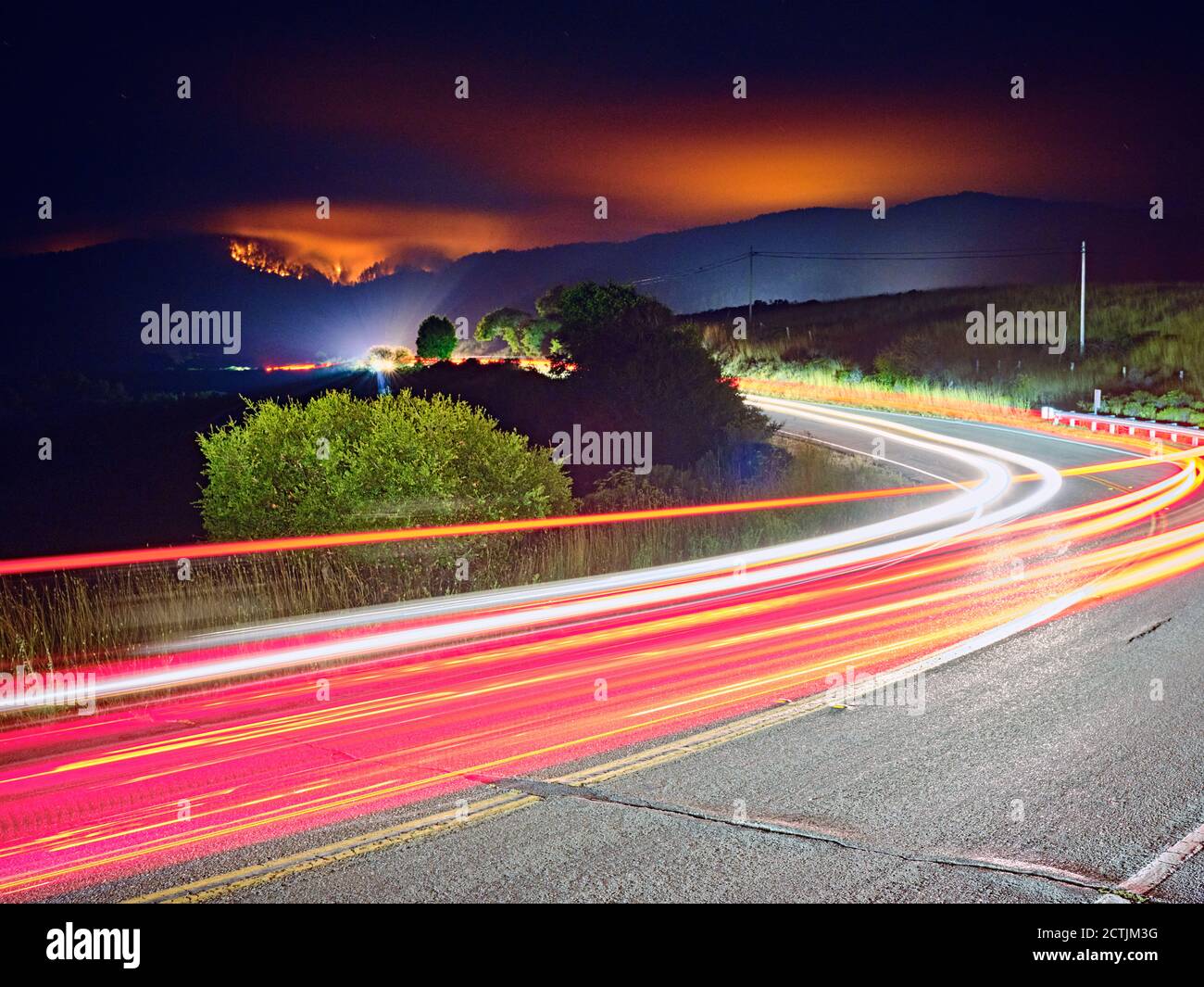 Woodward fire burning in Point Reyes National Park, headlights on road ...