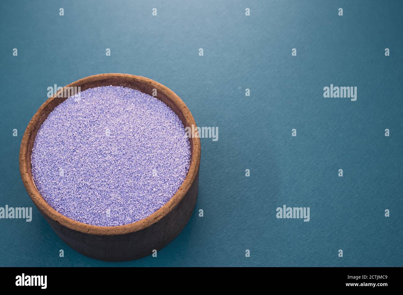 Shot of colored violet sand in a bowl Stock Photo - Alamy