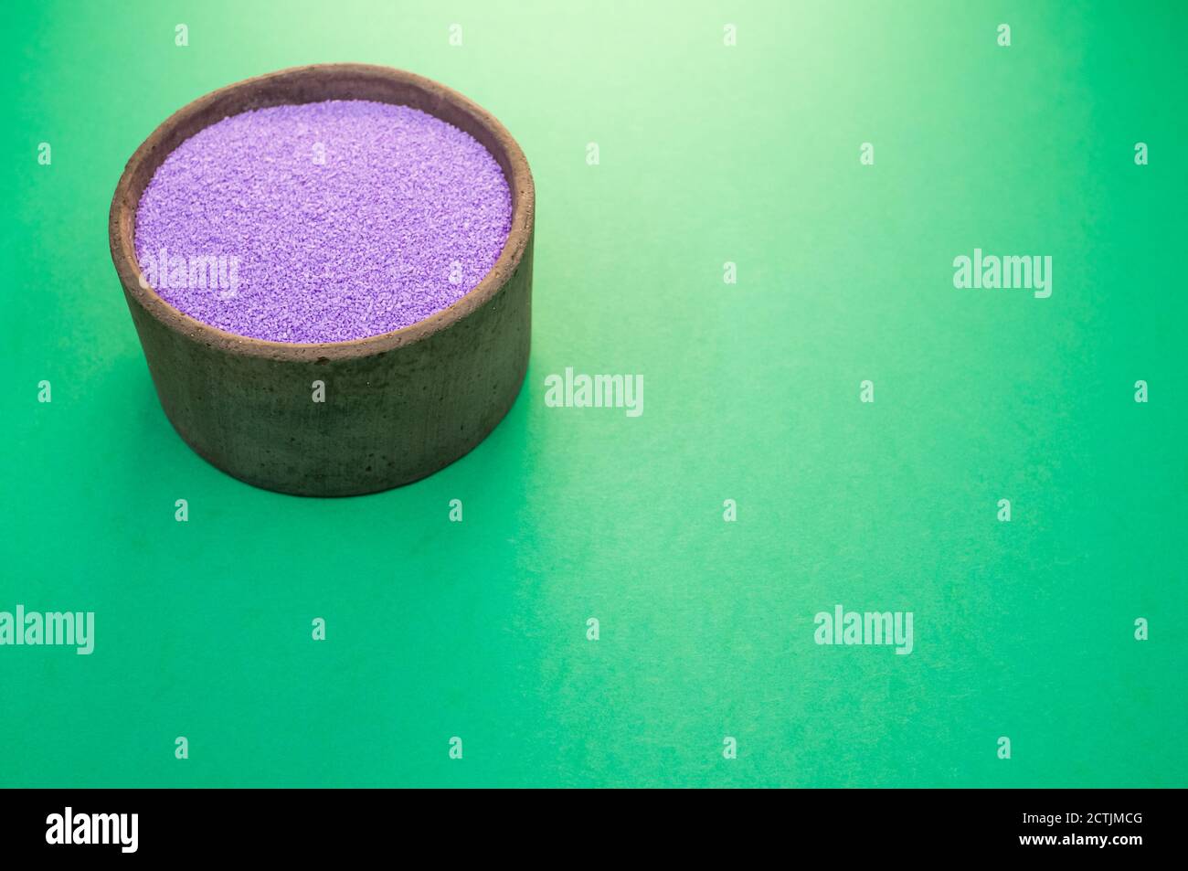 Shot of colored violet sand in a bowl Stock Photo - Alamy