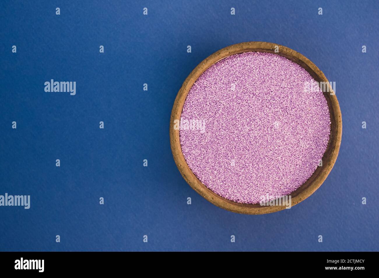 Shot of colored violet sand in a bowl Stock Photo - Alamy
