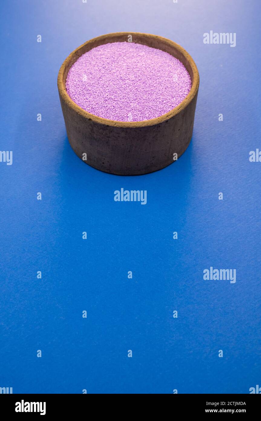 Shot of colored violet sand in a bowl Stock Photo - Alamy