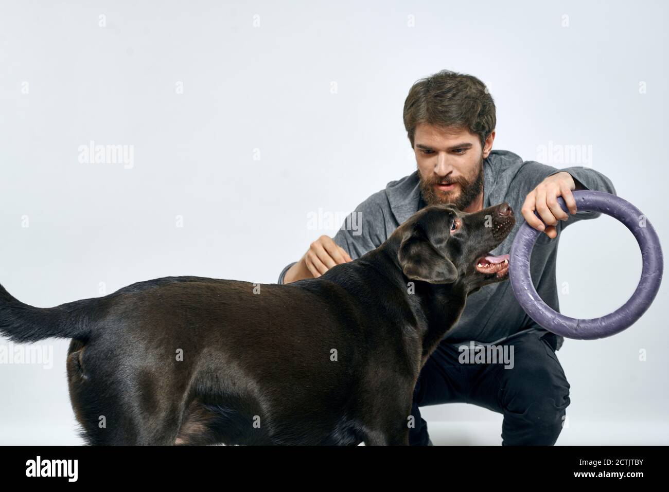 happy owner with pet black dog training model emotions Stock Photo - Alamy