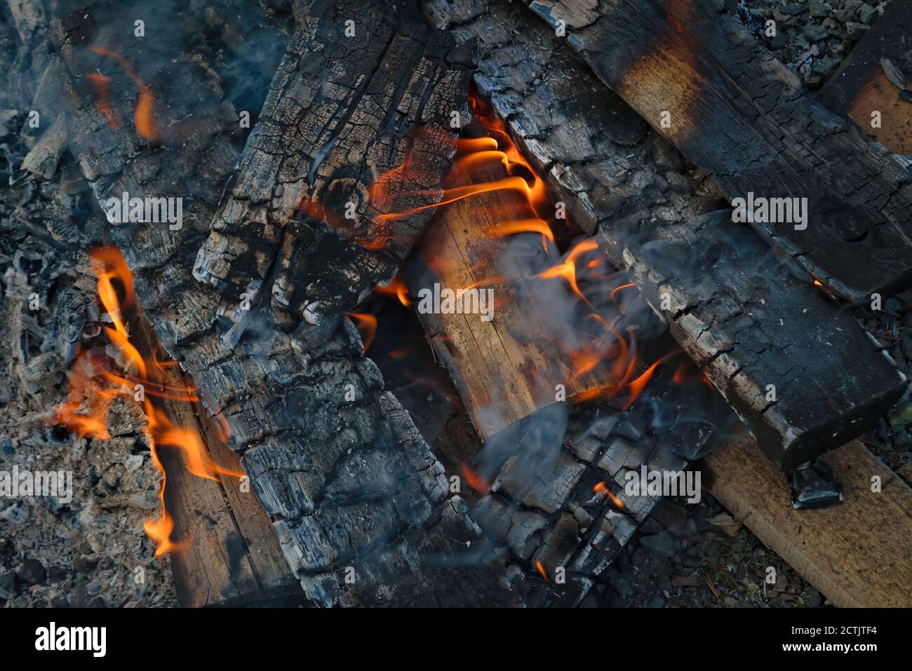 Burning log of wood close-up as abstract background. The hot embers of ...