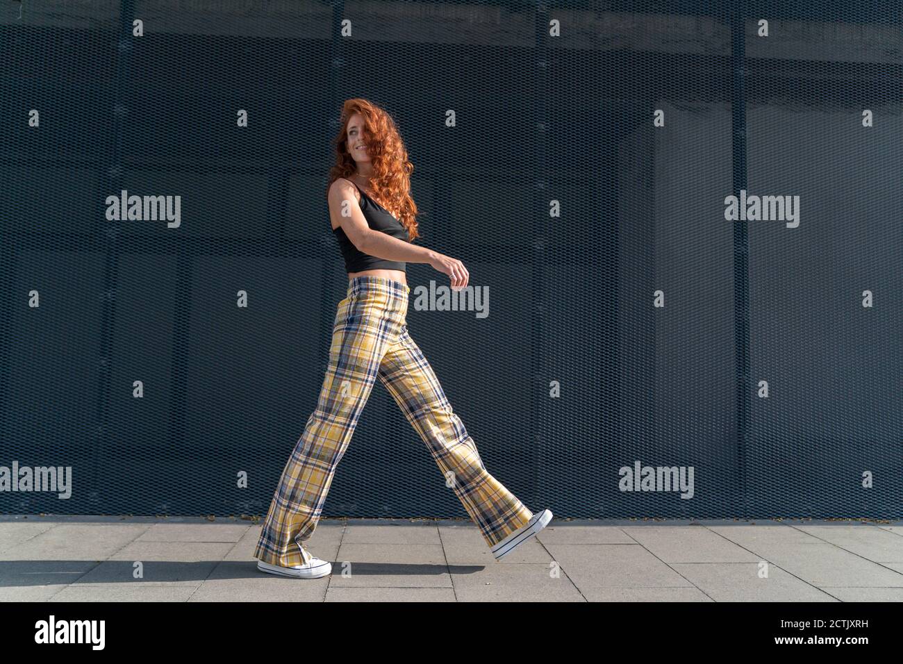 Black woman walking away on sidewalk hi-res stock photography and ...