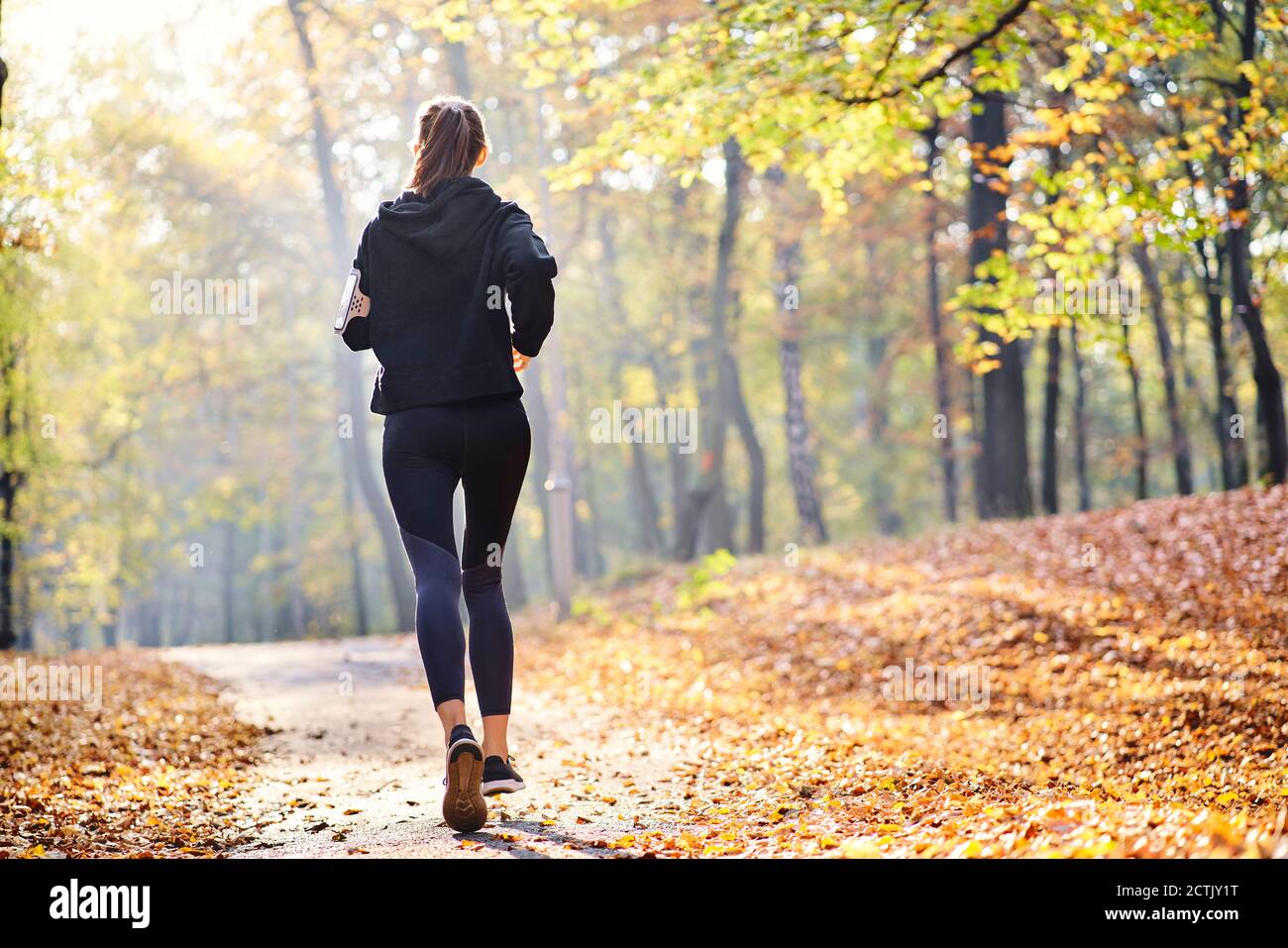 Woman running forest rear hi-res stock photography and images - Alamy