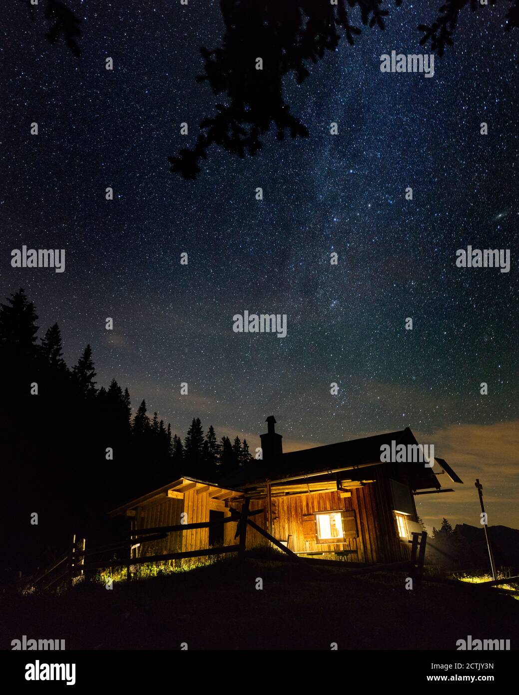 Starry night sky over secluded mountain hut Stock Photo - Alamy