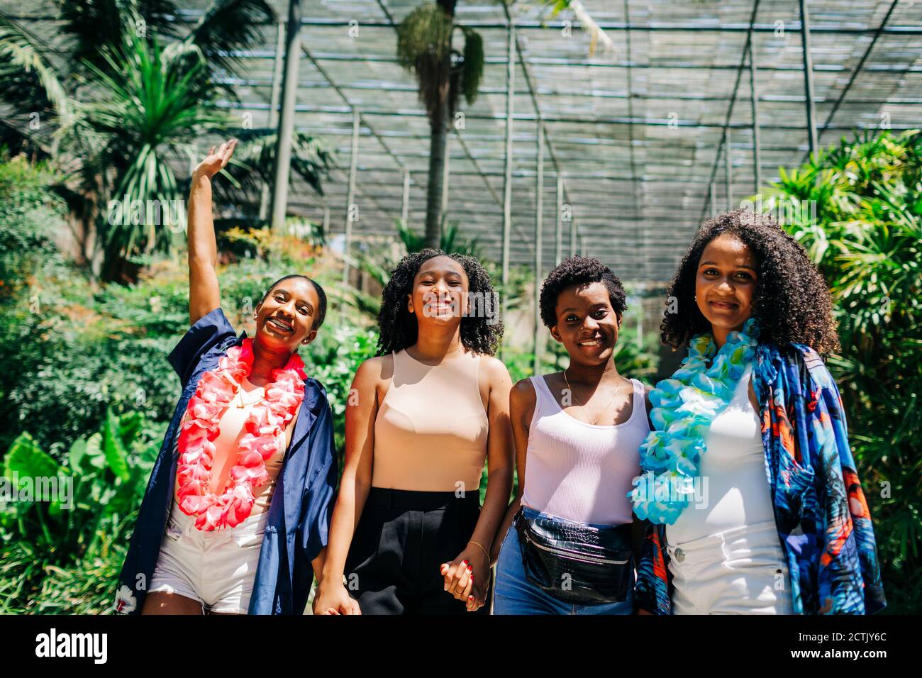 Four friends holding hands arms hi-res stock photography and images - Alamy