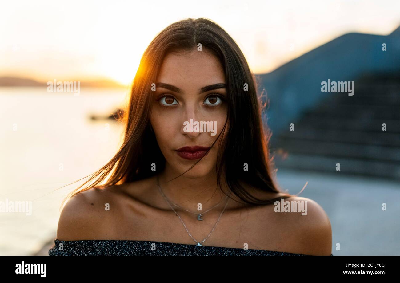 Beautiful woman standing at promenade during sunset Stock Photo - Alamy