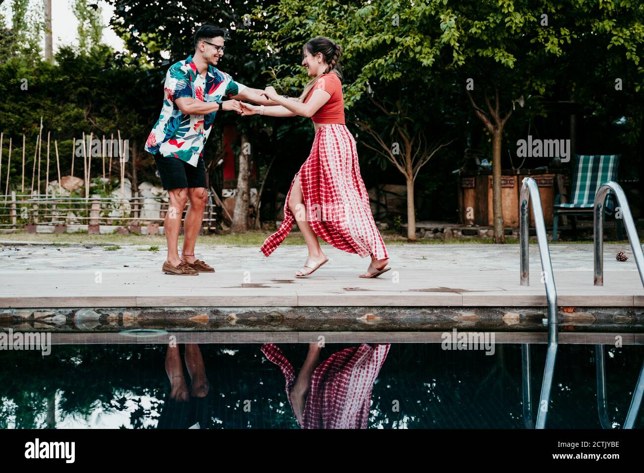 Man and women dancing by poolside Stock Photo - Alamy