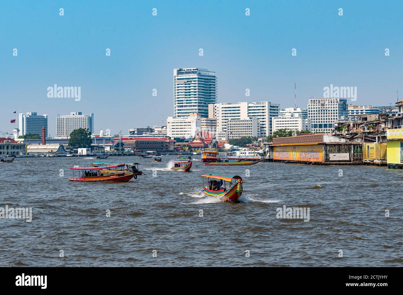 Thailand, Bangkok, Ferries on Chao Phraya river with city skyline in ...