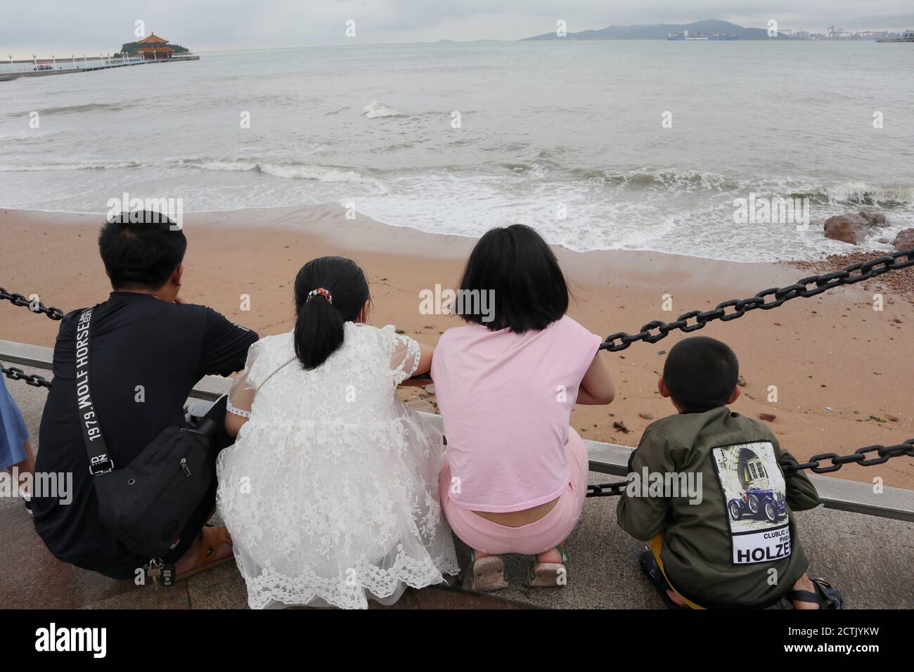 Citizens watch huge waves continuously attacking the shore as the ...
